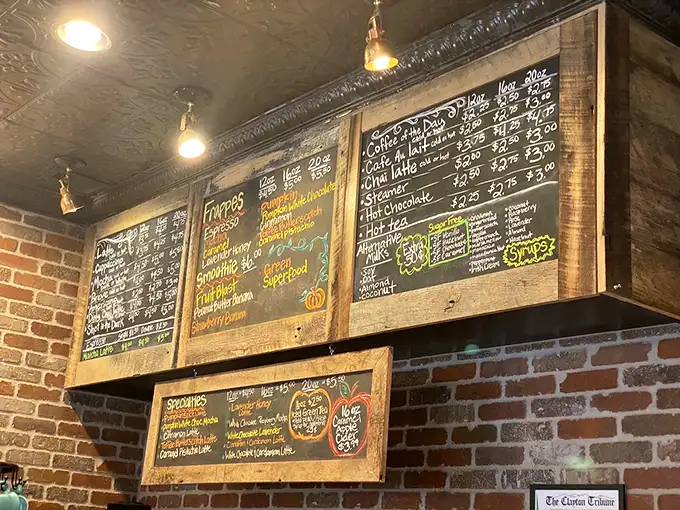 The chalkboard menu isn't just information—it's a promise of caffeinated bliss. Each carefully written item represents a potential life-changing sip waiting to happen.