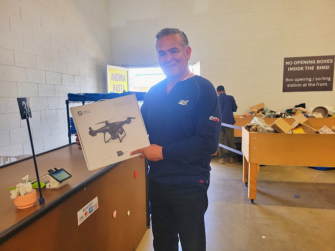 That moment when you score a drone for a fraction of retail. His smile says it all – part victory, part "wait till my friends hear about this!"