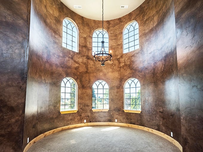 This circular tower room with its arched windows and wrought-iron chandelier feels like stepping into a scene from "Game of Thrones"—minus the impending doom.