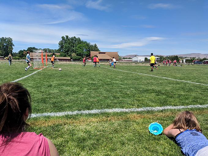 Kids playing soccer under blue skies in Union Gap—where affordable living means more time for community and less worrying about bills.