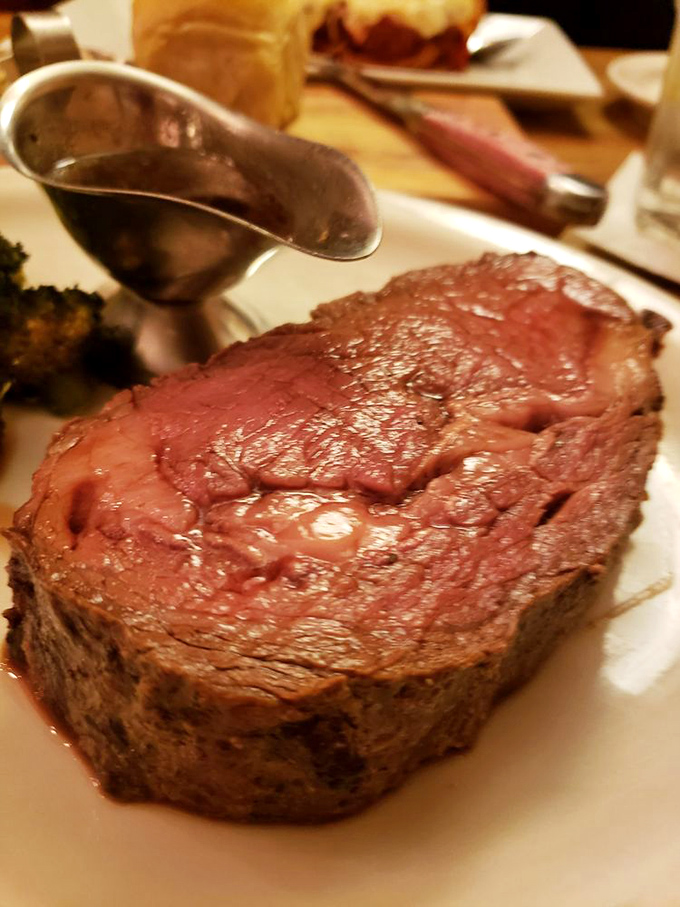Prime rib perfection on a plate—so perfectly pink it could make a vegetarian question their life choices. Those roasted potatoes aren't just sidekicks; they're co-stars.