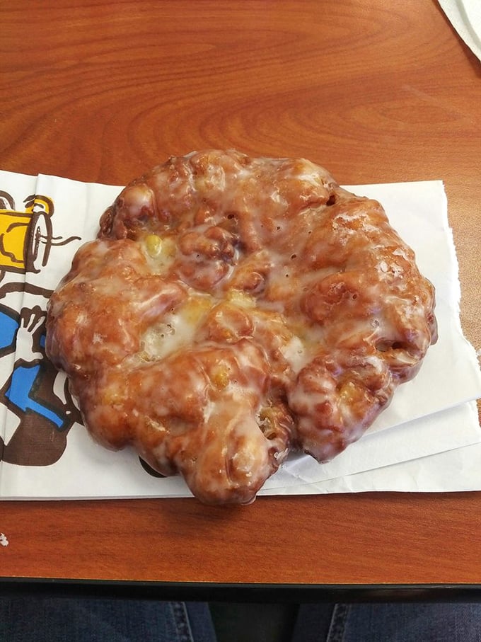 Behold the heavyweight champion of fritters—a gloriously irregular masterpiece where crispy exterior gives way to tender, apple-studded interior. Napkins required, regrets impossible.