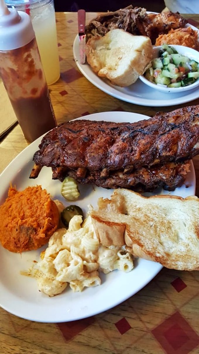 These ribs don't just fall off the bone—they practically leap onto your fork in slow motion. The bark alone deserves its own fan club.