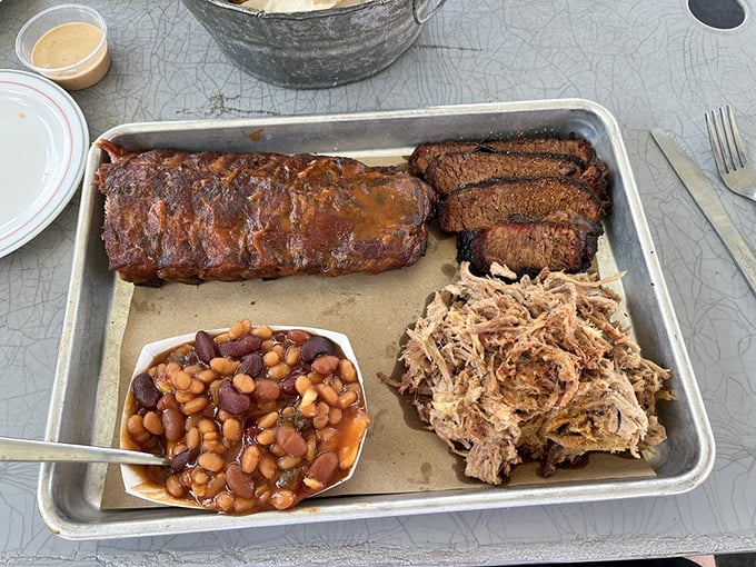 The holy trinity of barbecue bliss: ribs with that perfect bark, brisket with the telltale smoke ring, and pulled pork that practically melts on sight.