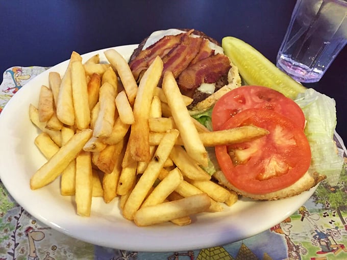 A burger that requires a game plan before attacking. Those golden fries aren't just a side—they're co-stars in this delicious production of "Lunch: The Musical."