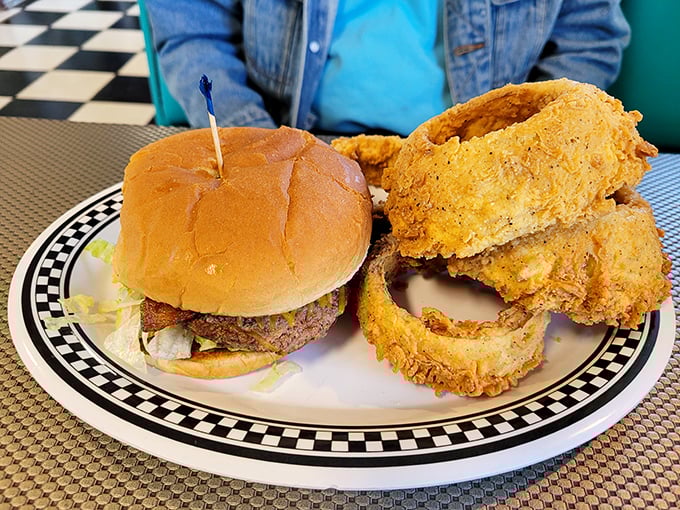 This isn't just a burger—it's architectural perfection. The golden-battered onion rings play supporting role to a star that needs no introduction.