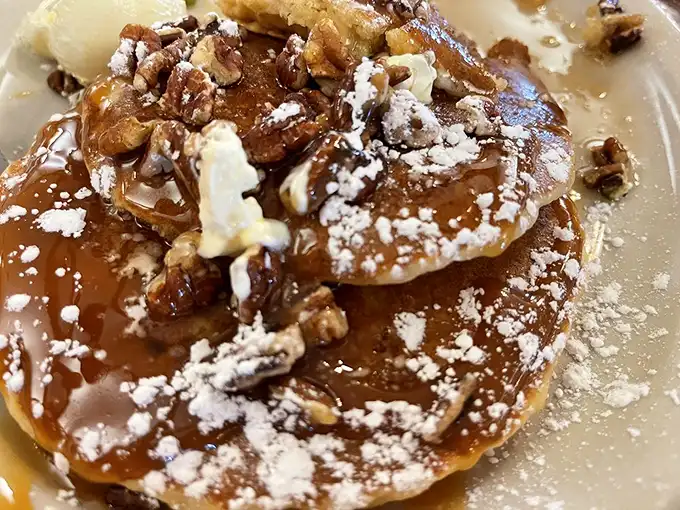 This caramel nut pancake isn't just breakfast—it's dessert with an alibi. The powdered sugar dusting provides plausible deniability for morning decadence.