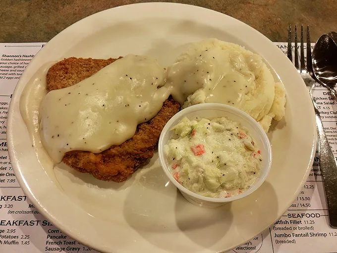 Behold the star attraction – chicken fried steak smothered in peppery gravy alongside creamy mashed potatoes and coleslaw that grandma would approve of.