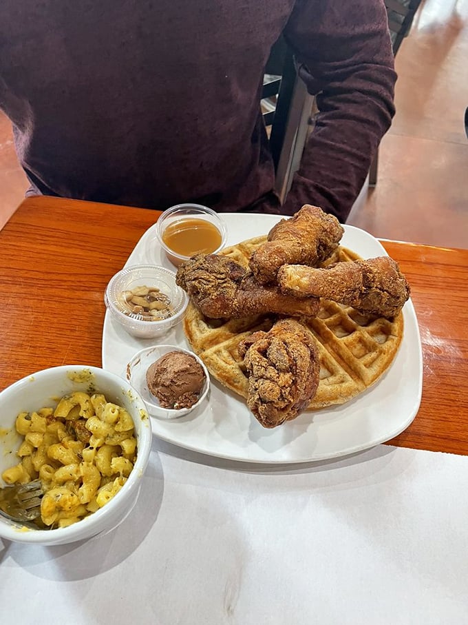 Golden fried chicken perched atop a perfect waffle with a side of mac and cheese – a trio so harmonious they could release a platinum album.