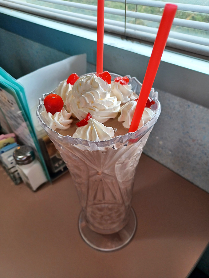 This isn't just a milkshake—it's an engineering marvel with whipped cream architecture that deserves its own area code.