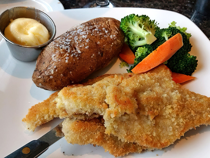 Golden-fried perfection meets garden-fresh veggies. That baked potato isn't just a side—it's the perfect companion for a seafood adventure.
