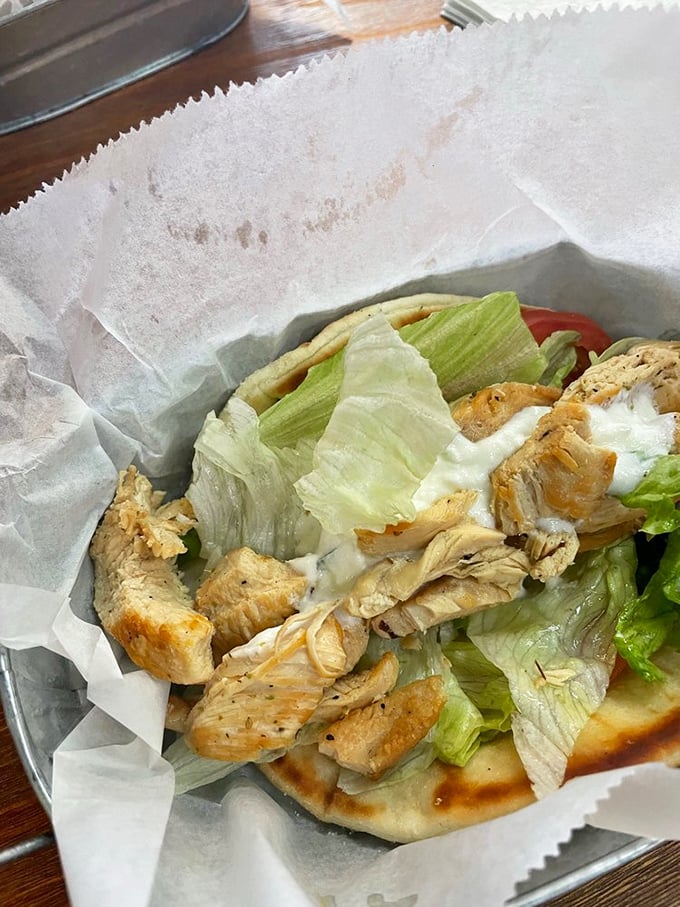 This isn't just a chicken gyro—it's a masterclass in simplicity. Tender meat, crisp lettuce, and that tzatziki sauce that dreams are made of.