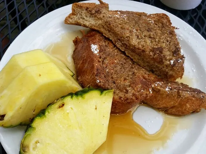Golden-brown French toast with a side of fresh fruit—proof that breakfast perfection exists and it's hiding in Petoskey.