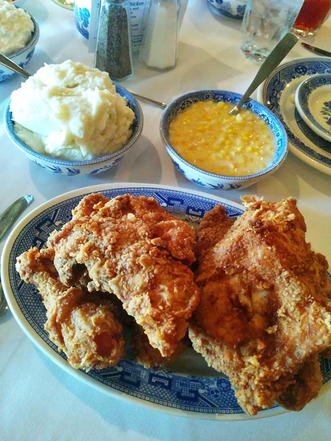Golden-brown chicken with a crust that shatters like glass, flanked by cloud-like mashed potatoes and corn so creamy it could make a dairy farmer blush.