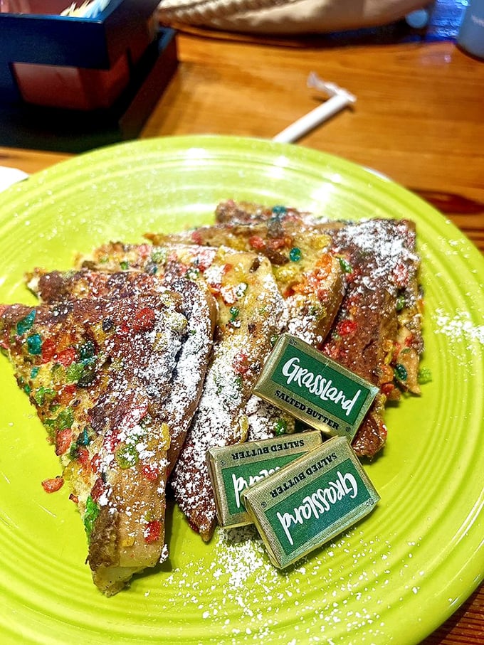 Fruity Pebble French toast that would make Fred Flintstone weep with joy—childhood nostalgia served on a lime-green plate.