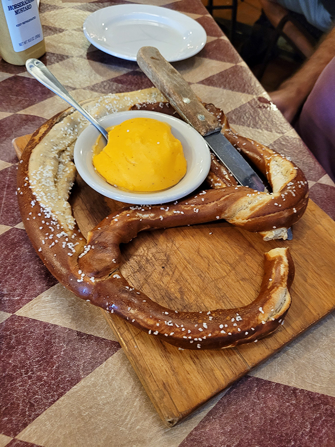 Behold the pretzel mothership! This golden-brown beauty with its center bowl of liquid gold cheese isn't just a snack—it's an engineering marvel of carb architecture. Photo credit: <a href="https://maps.google.com/maps/contrib/117078419973679420956" target="_blank" rel="noopener noreferrer">Lisa Marie</a>