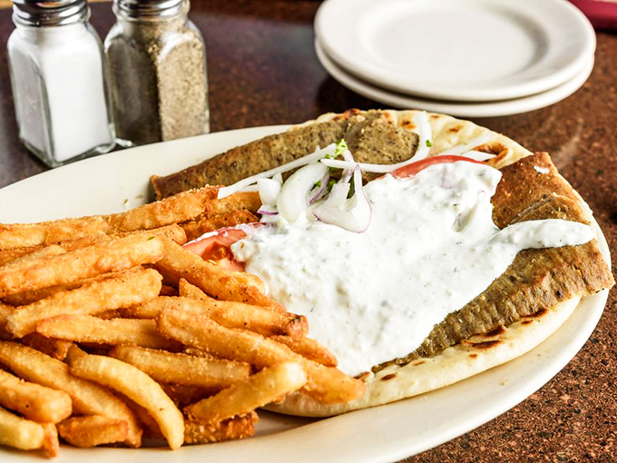 The gyro that launched a thousand cravings. Golden fries stand at attention beside a sandwich bursting with meat and tzatziki—a perfect harmony of textures.