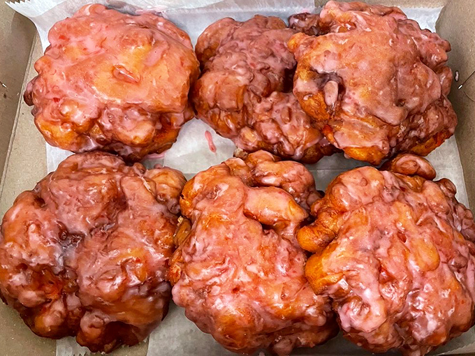 These aren't just apple fritters—they're irregular masterpieces of fried dough, each one a unique snowflake of glazed deliciousness.
