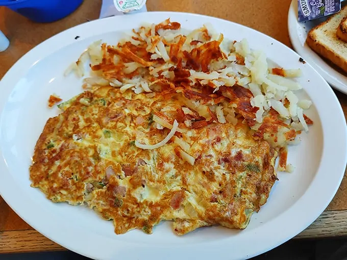 Eggs and cheese melted over crispy hash browns—a breakfast marriage made in heaven. This omelet doesn't need a prenup; it's already perfect