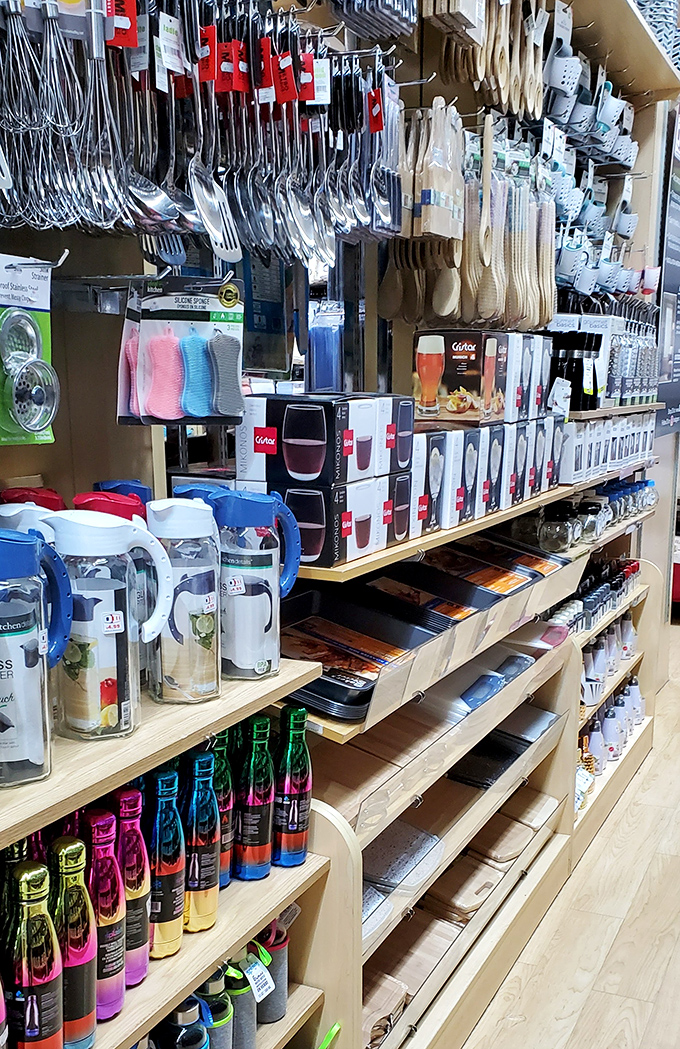 Kitchen gadget heaven where utensils hang like metallic stalactites, promising culinary adventures without the Manhattan kitchenware store prices.