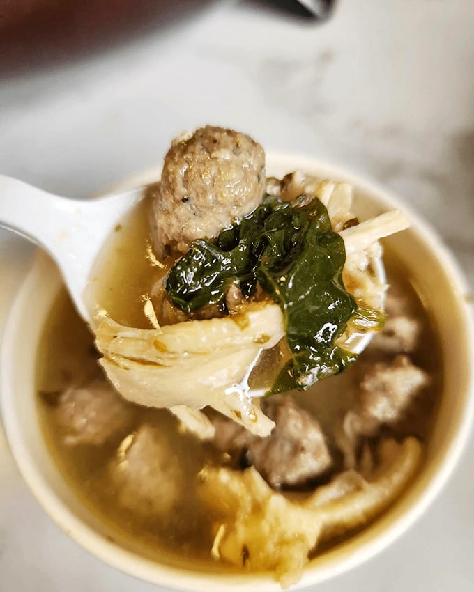 Behold the matzo ball soup that would make any Jewish grandmother nod in approval. That perfect golden broth with tender matzo balls floating like delicious clouds of comfort.