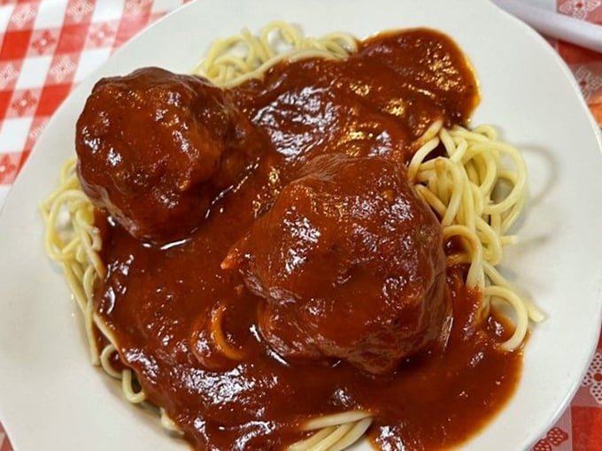 These meatballs aren't just sitting on the spaghetti—they're holding court. The sauce, rich and glossy, makes a compelling case for wearing a bib.