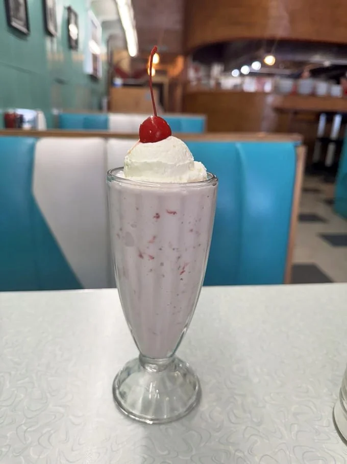 The cherry-topped milkshake isn't just dessert, it's therapy in a glass—creamy, dreamy, and worth every calorie.