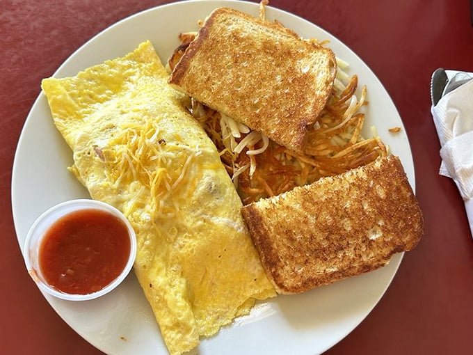 Breakfast perfection doesn't need fancy names—just a fluffy omelet, perfectly toasted bread, and hash browns that strike the ideal balance between crispy and tender.