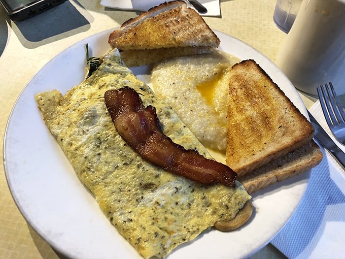 This isn't just an omelet—it's an edible monument to morning indulgence. Paired with perfectly golden toast and crispy bacon, it's the breakfast trifecta of champions.