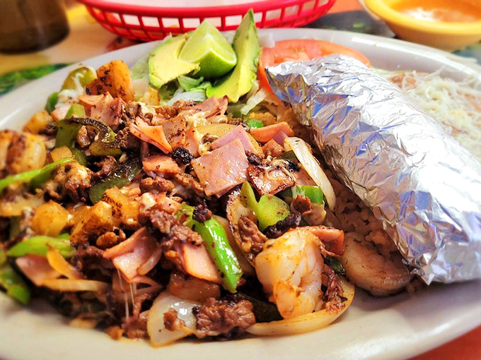 This burrito plate is the edible equivalent of a warm hug. The foil-wrapped masterpiece sits proudly alongside its rice and bean companions.