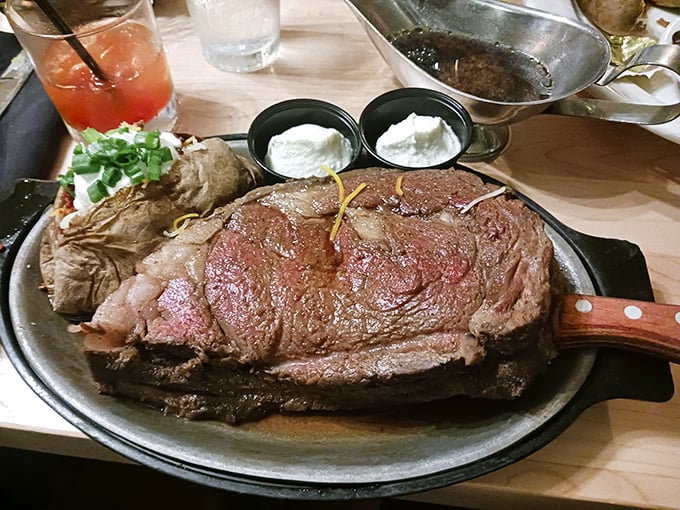 The prime rib arrives like a carnivore's dream painting—perfectly pink, trailing juice, with sides that know their supporting role in this meaty masterpiece.