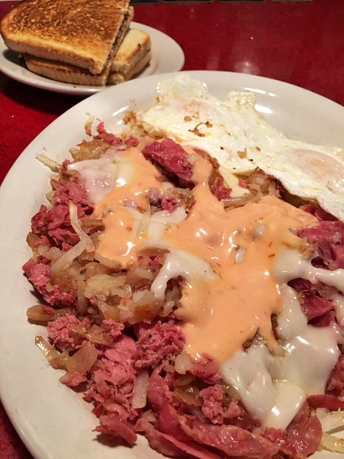 Corned beef hash elevated to an art form. That orange cheese sauce cascading over crispy potatoes and tender meat is what breakfast dreams are made of.