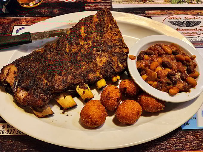 Behold the barbecue trifecta: ribs with perfect bark, hush puppies with golden crunch, and beans that have clearly been simmering since breakfast.