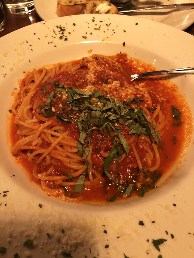 Spaghetti pomodoro – proof that simplicity reigns supreme. Fresh basil confetti atop a perfectly balanced marinara that would make an Italian grandmother nod in approval.