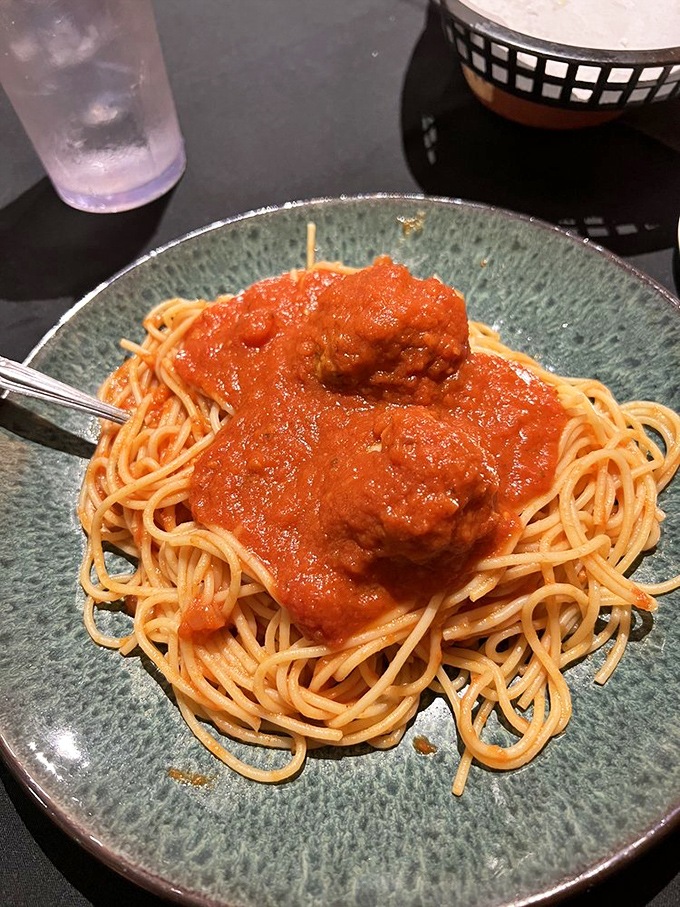 Spaghetti and meatballs done right—tender pasta swimming in rich marinara with meatballs so perfect they'd make any nonna proud.