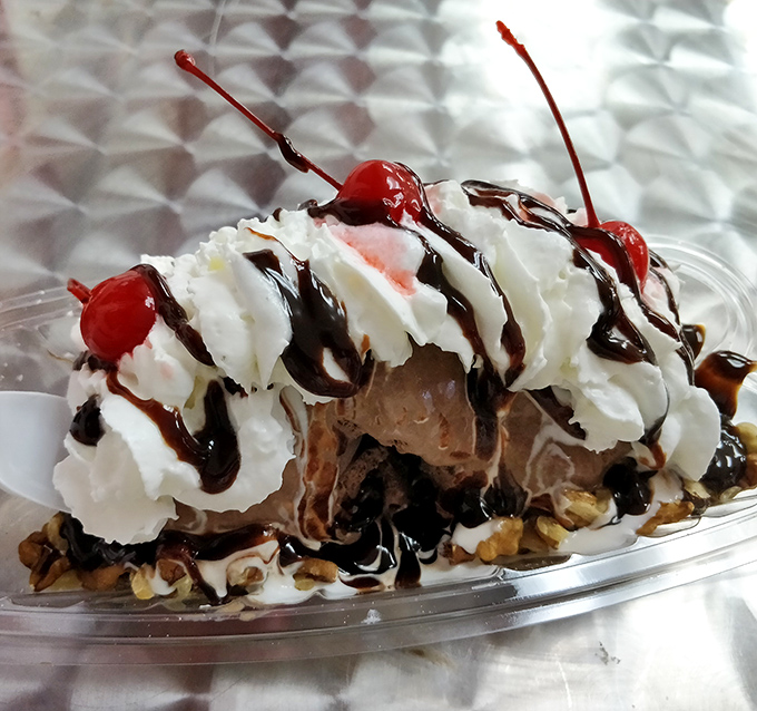 This isn't just a sundae—it's an architectural masterpiece where hot fudge cascades over cold cream, topped with cherries that practically wink at you.