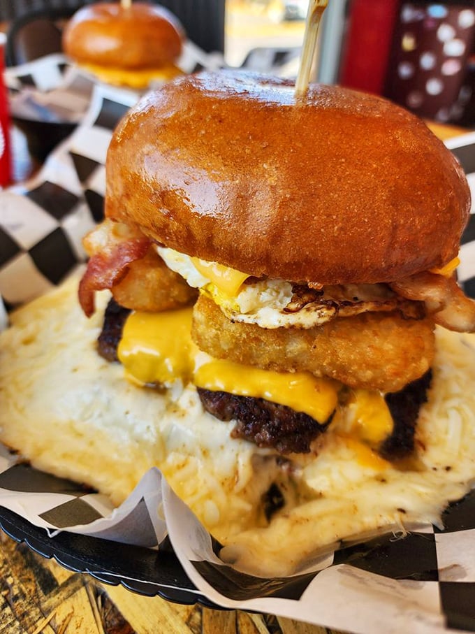 This towering masterpiece isn't just a burger—it's architecture with cheese. The golden bun gleams like a treasure chest protecting delicious secrets within.