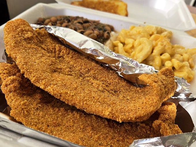 Golden-crusted catfish that shatters with each bite, alongside creamy mac and cheese and savory beans. This is what food dreams are made of.