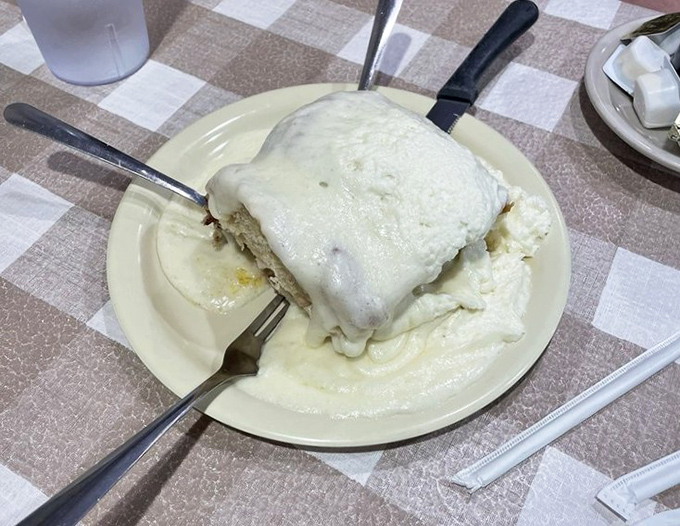 The legendary cinnamon roll doesn't just arrive at your table – it makes an entrance. Frosting cascades down the sides like a delicious avalanche.