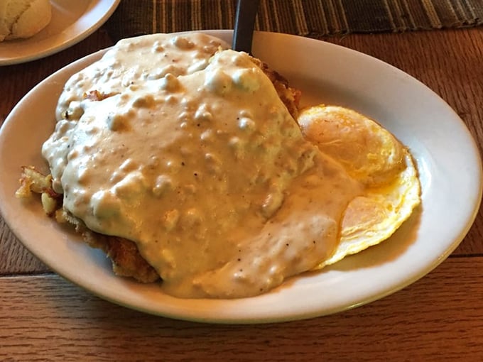 Behold the legendary country fried steak—a crispy, golden masterpiece swimming in creamy gravy that's worth every mile of the journey.