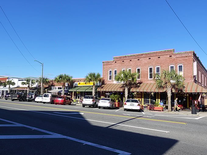 Brick facades and striped awnings create a downtown straight from a Norman Rockwell painting—if Rockwell had discovered oysters and Gulf breezes.