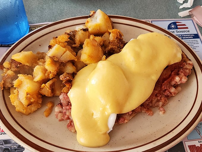 Hollandaise sauce cascading over perfectly poached eggs and corned beef hash. This plate doesn't need a filter—it needs your undivided attention.