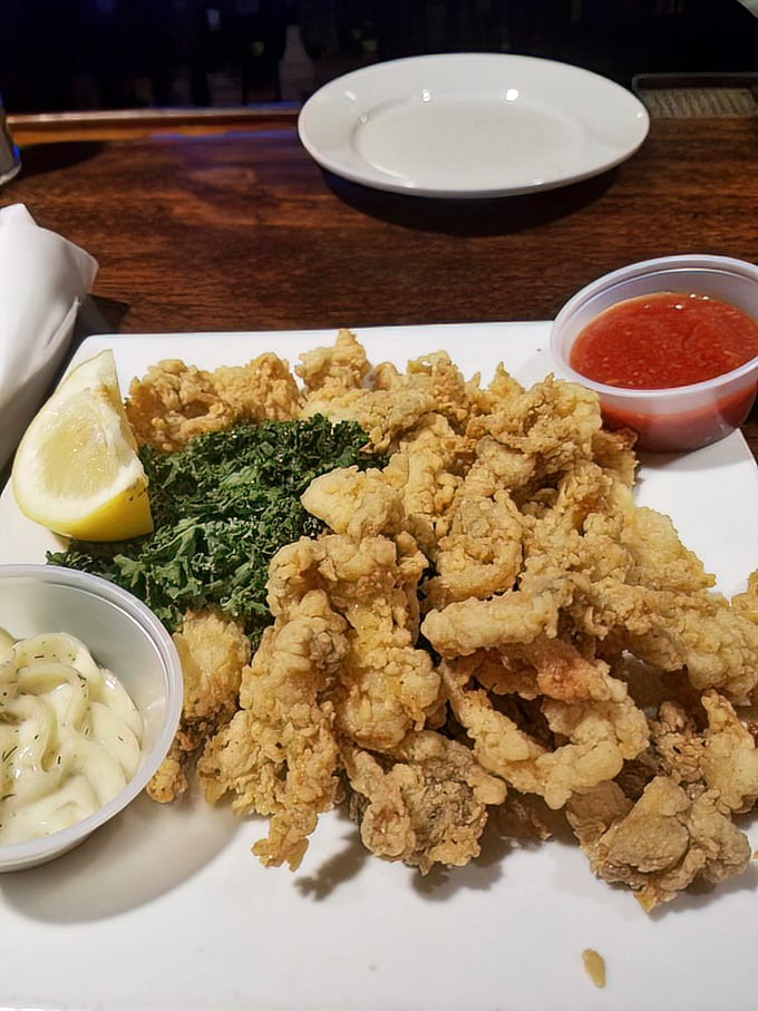 Golden-battered whole belly clams—crispy outside, tender inside—sit proudly alongside their dipping companions. The holy trinity of seafood perfection!