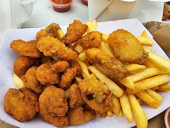Golden treasures from the deep! These fried clams and fries aren't just food—they're edible proof that perfection needs no fancy presentation.