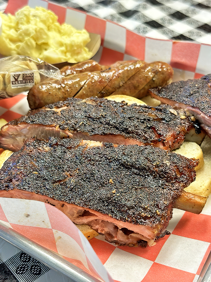 Ribs with a bark so perfect they should be in a museum. That smoke ring isn't just color—it's a timeline of patience and expertise.