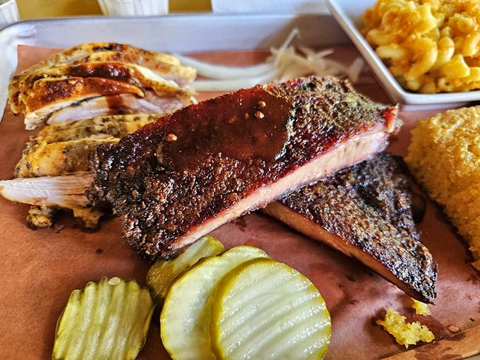 Behold the holy trinity of barbecue – ribs with that perfect bark, tender chicken, and a side of mac and cheese that's worth every calorie.