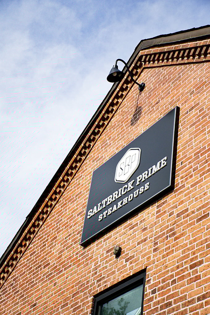 Saltbrick Prime's sign against that brick backdrop is like a beacon for beef lovers – simple, bold, and promising greatness.