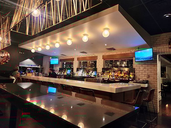 The bar at KC Prime gleams with possibility – each bottle a promise that your evening is about to get significantly better.