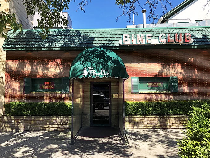 That classic brick exterior isn't just a restaurant—it's a time machine to when steakhouses ruled the dining scene.