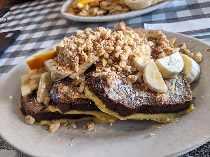 Banana bread transformed into French toast—a breakfast innovation that deserves its own Nobel Prize. Those walnuts add the perfect crunch factor.